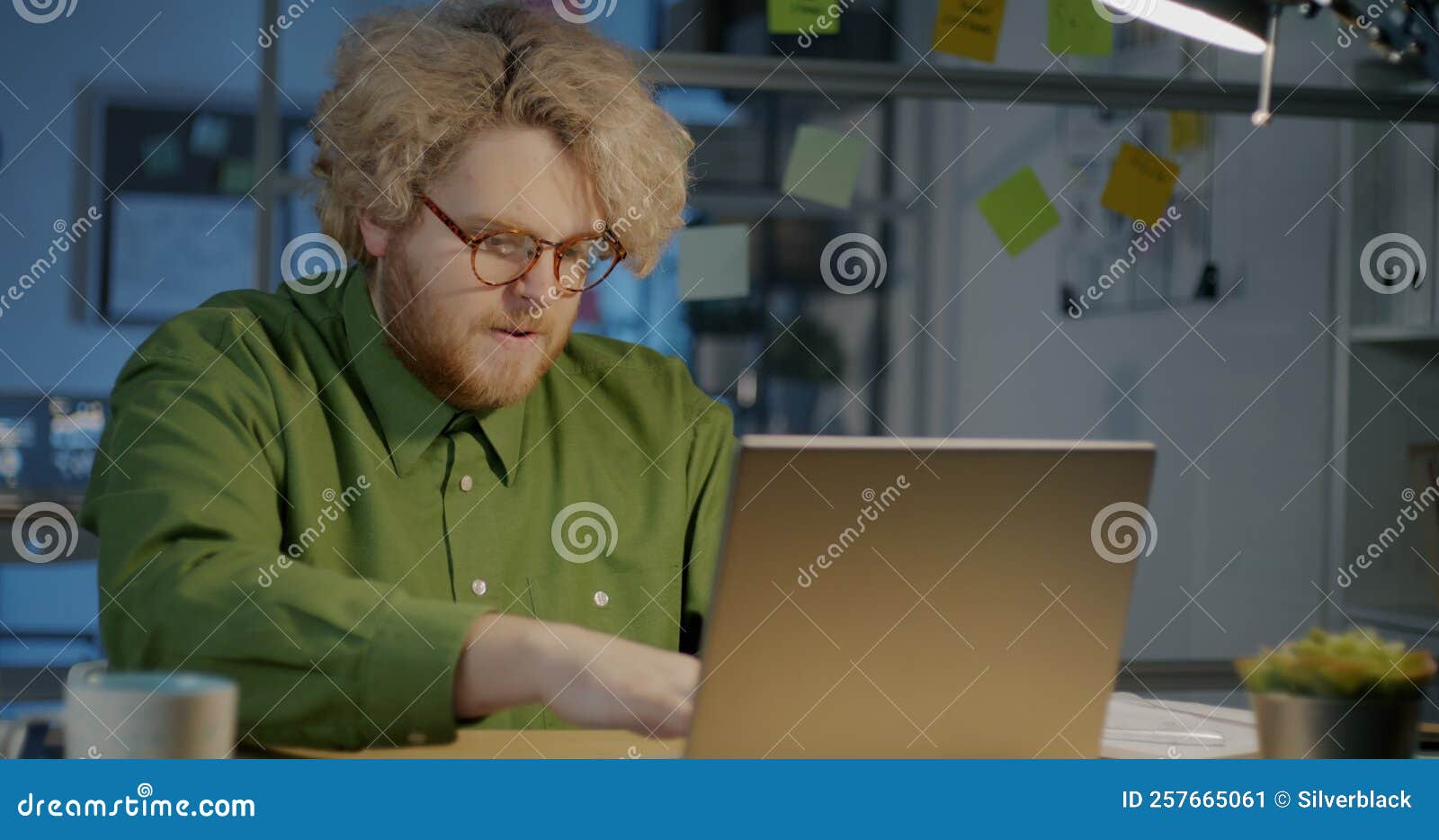 Determined Office Worker Using Laptop Late at Night Typing and Looking ...