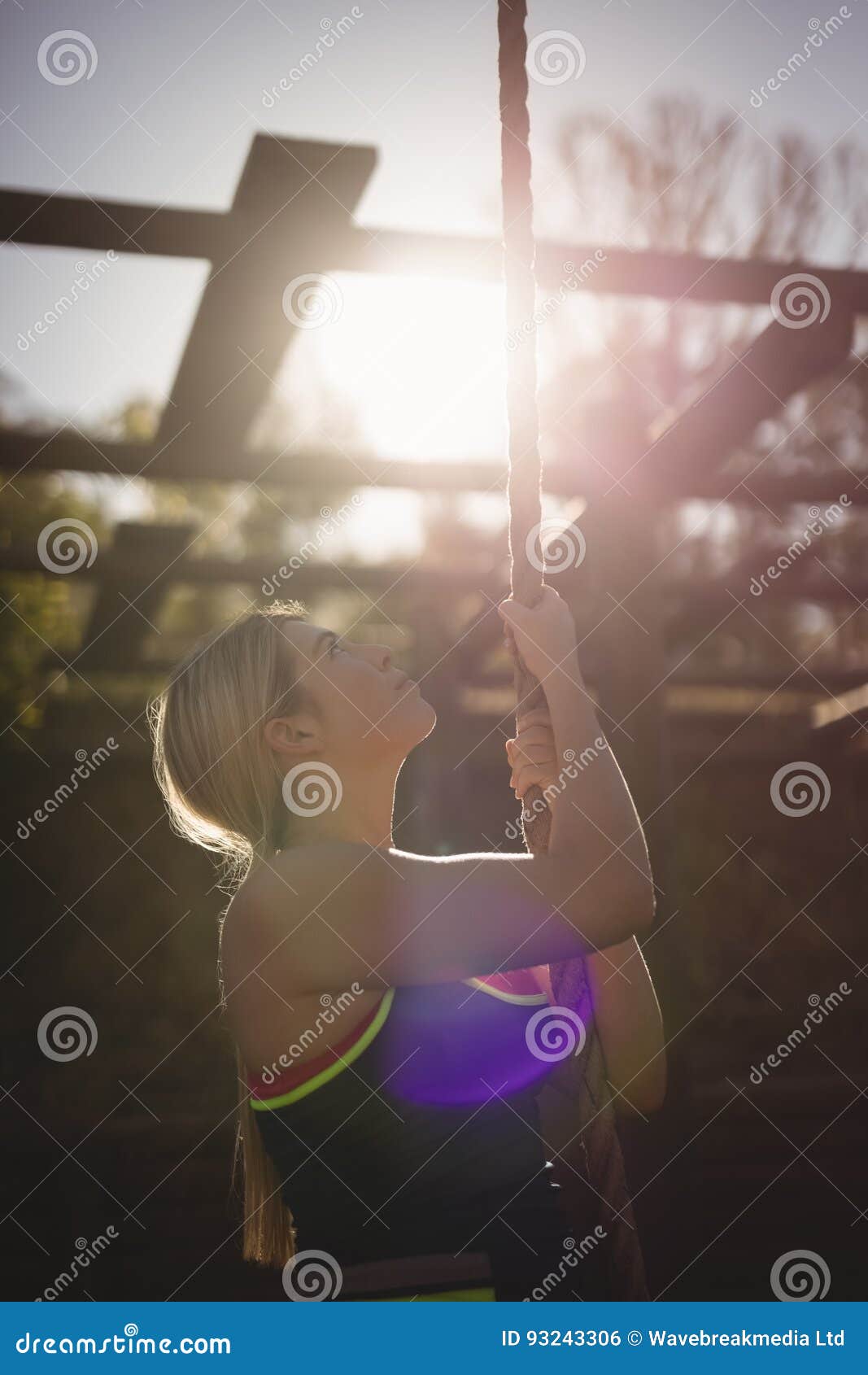 Determined Woman Climbing Rope during Obstacle Course Stock Photo ...