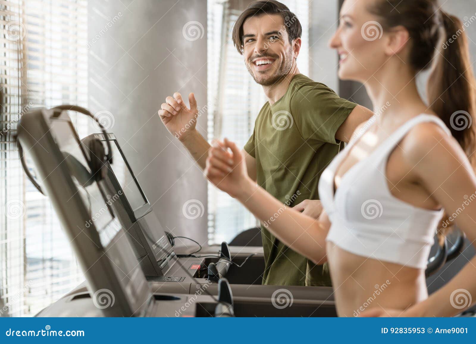 Determined Young Man Smiling while Running on Treadmill during H Stock ...