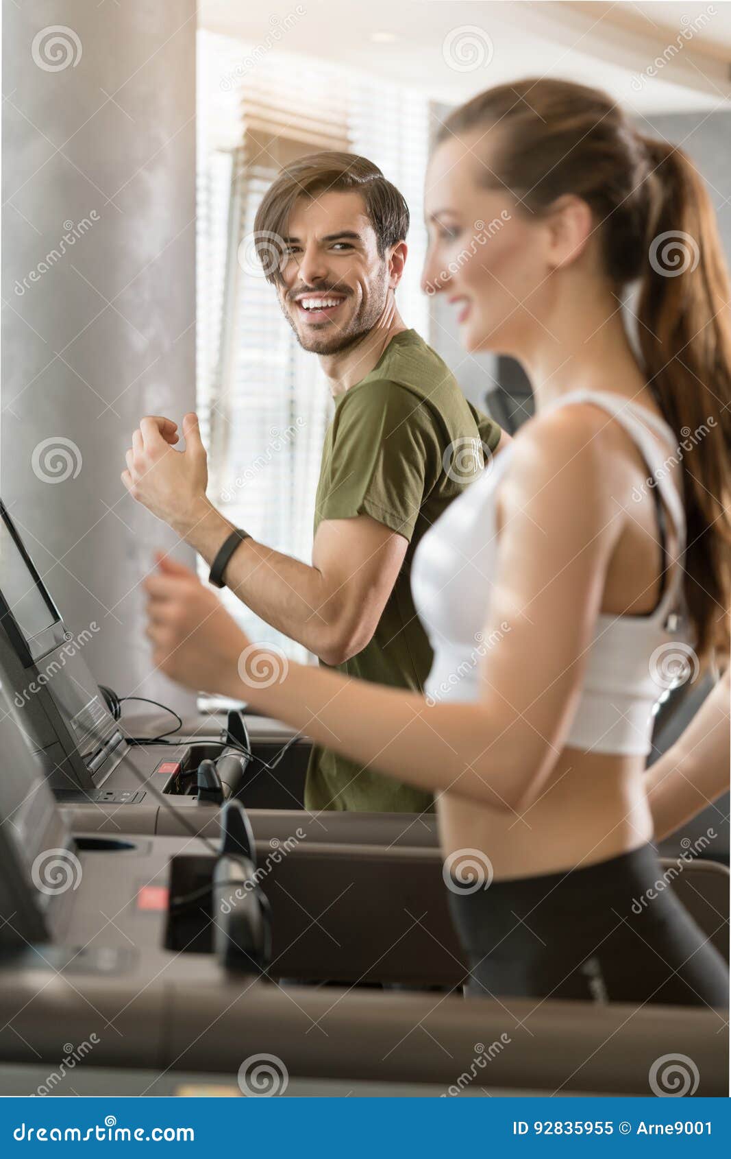 Determined Young Man Smiling while Running on Treadmill during H Stock ...