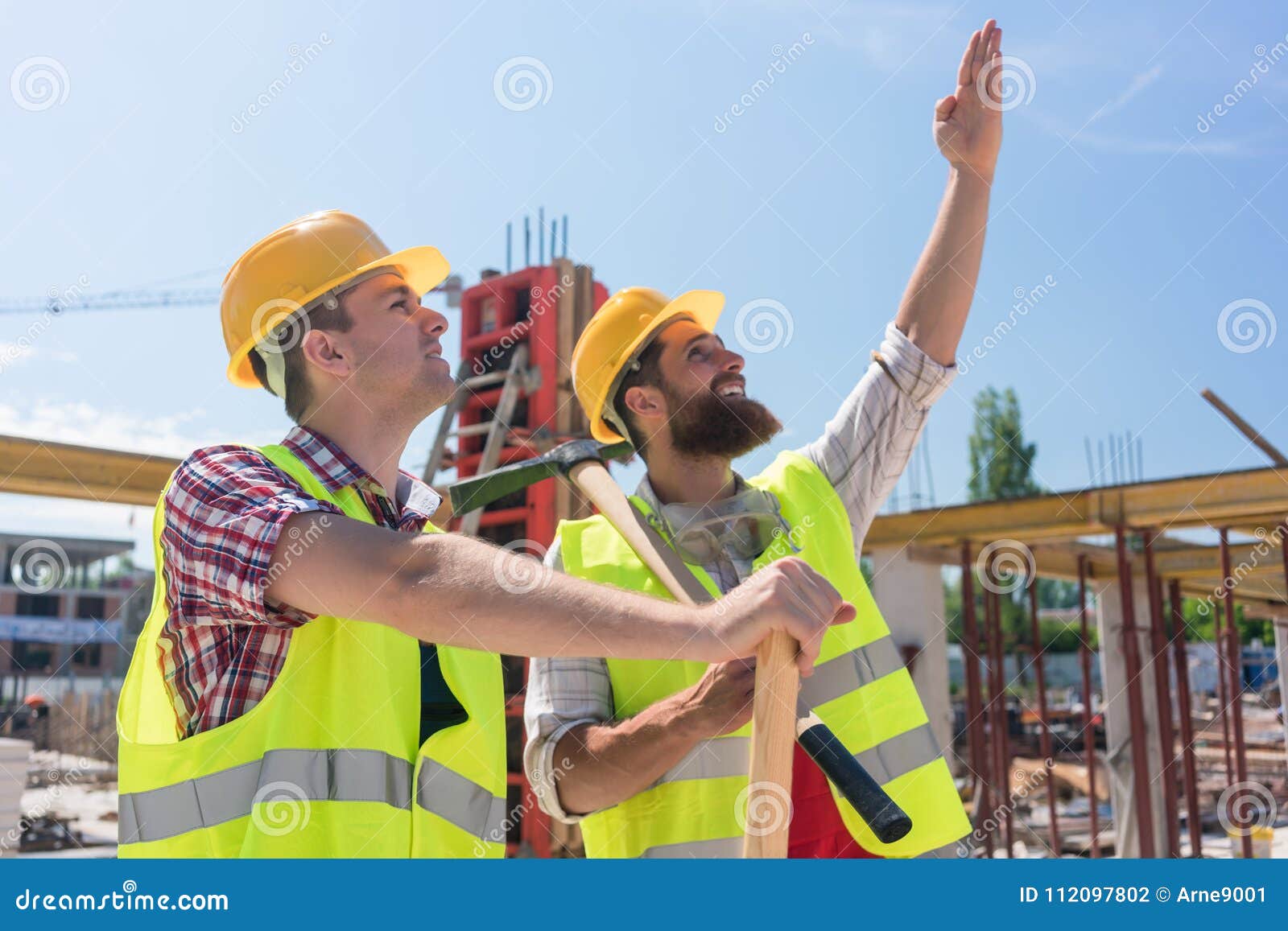 Determined Young Worker Pointing Up while Imagining the Height of a ...