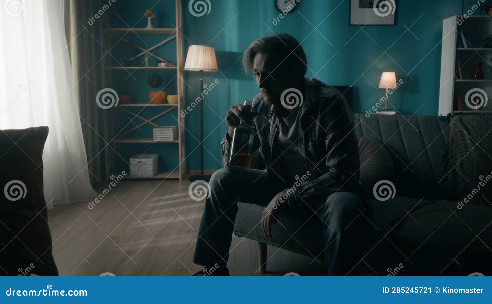 A Devastated Man Sits in a Dark Room with a Bottle of Alcohol. a Sad ... A Devastated Man Sits in a Dark Room with a Bottle of Alcohol. a Sad ...