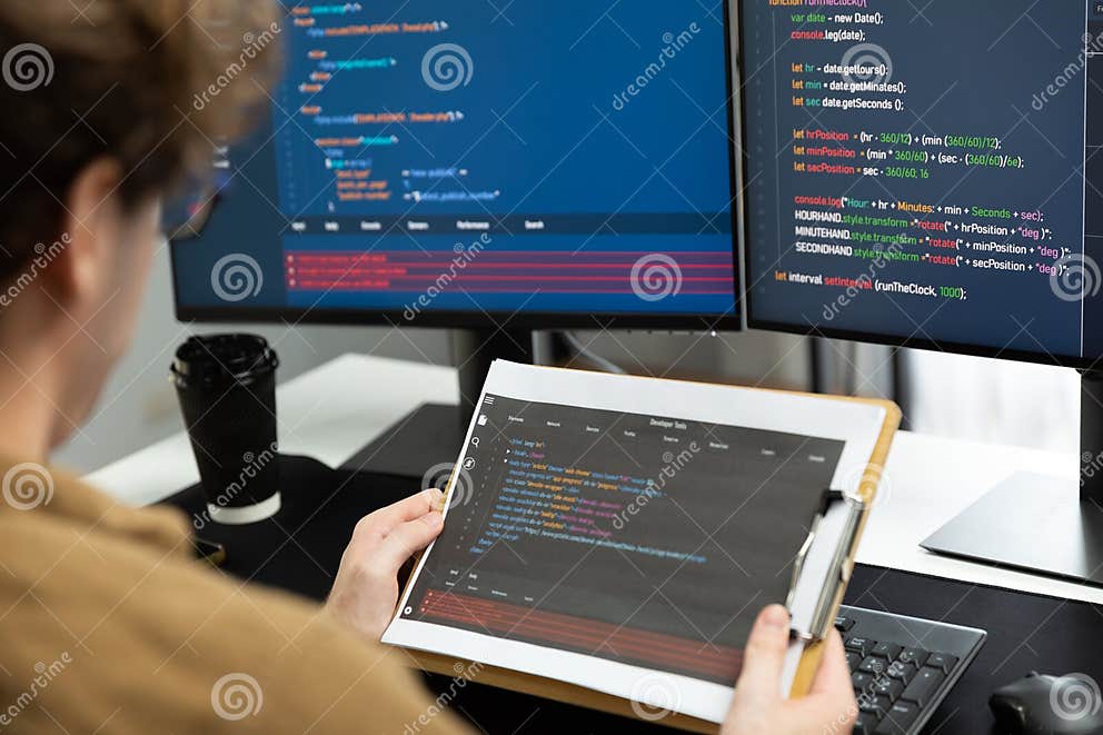 It Developer Reading Coding on Document Paper Software with Screens ... It Developer Reading Coding on Document Paper Software with Screens ...