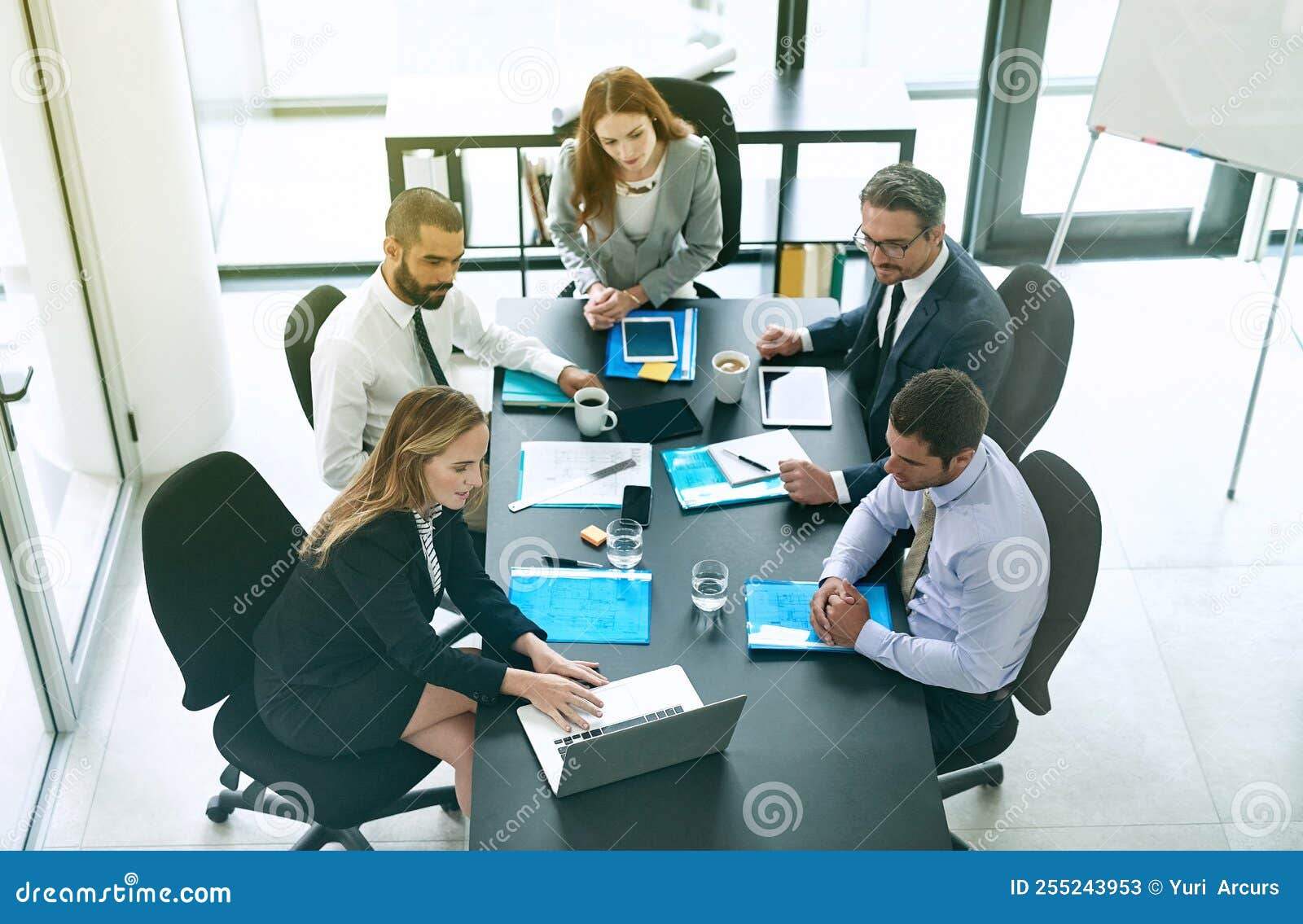 Developing a Solid Action Plan As a Team. a Team of Executives Having a ...