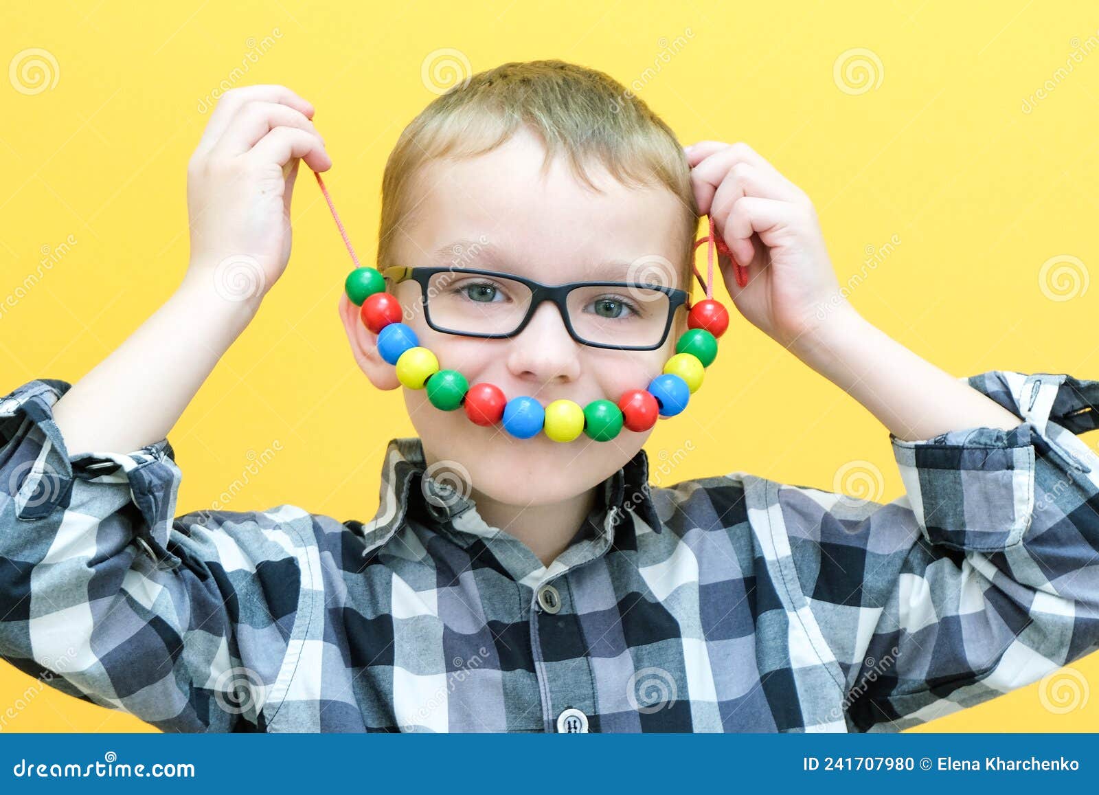 Development of Fine Motor Skills. Toddler Boy is Stringing Beads on a ...