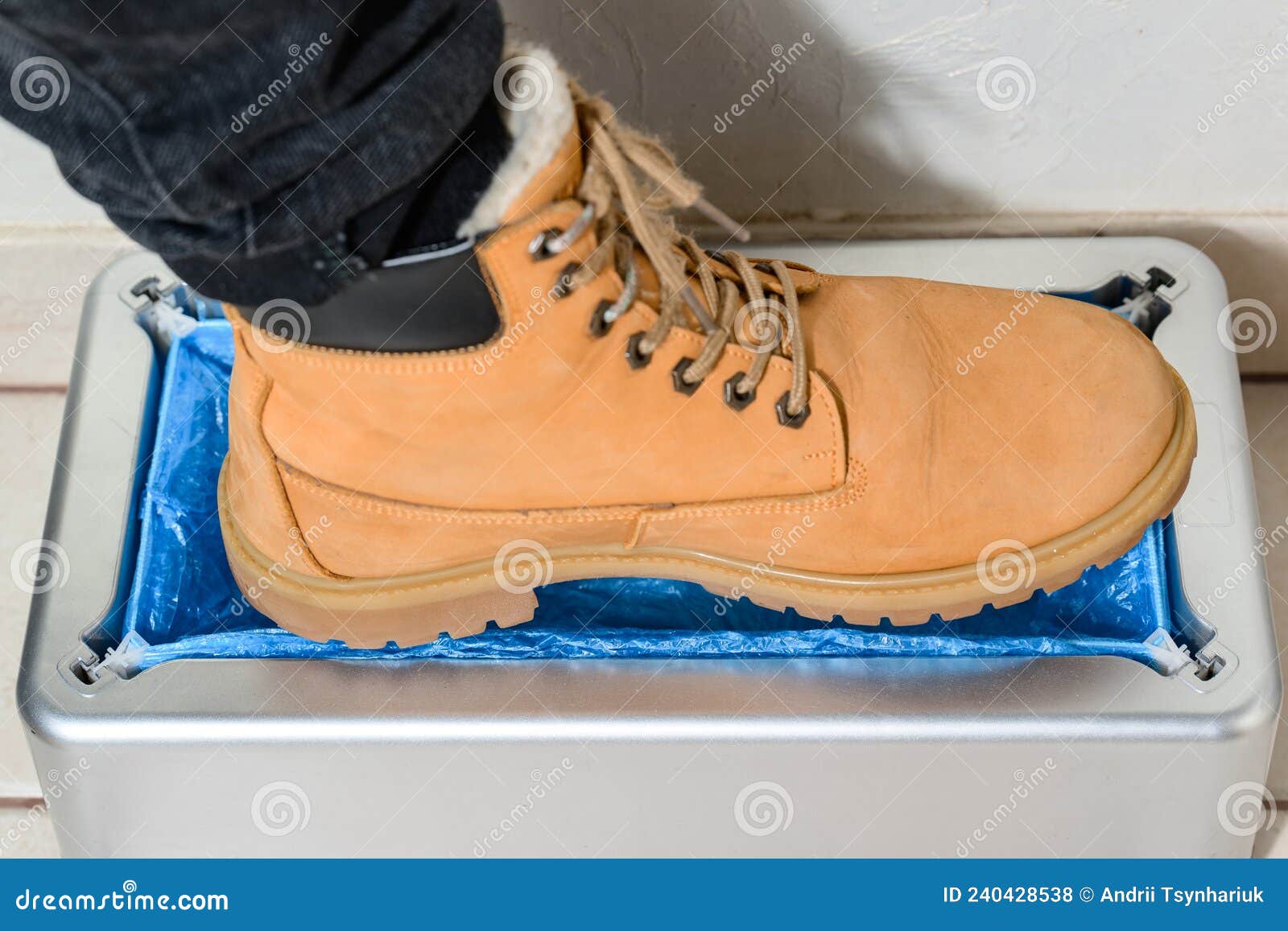 Device for Automatic Dressing of Boot Covers, a Man in Brown Shoes Puts ...