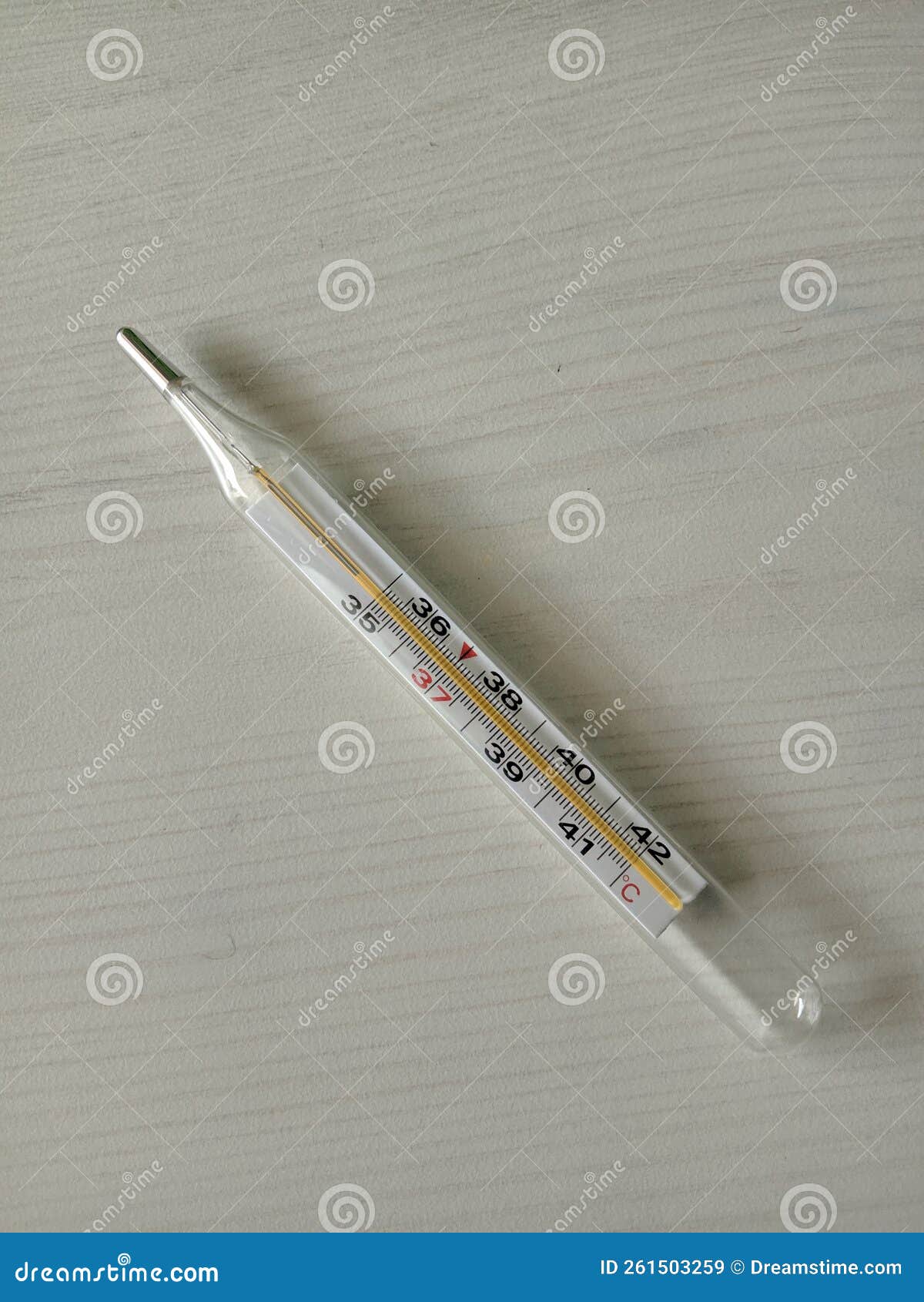 A Device for Checking Body Temperature, a Thermometer. on a White Table ...
