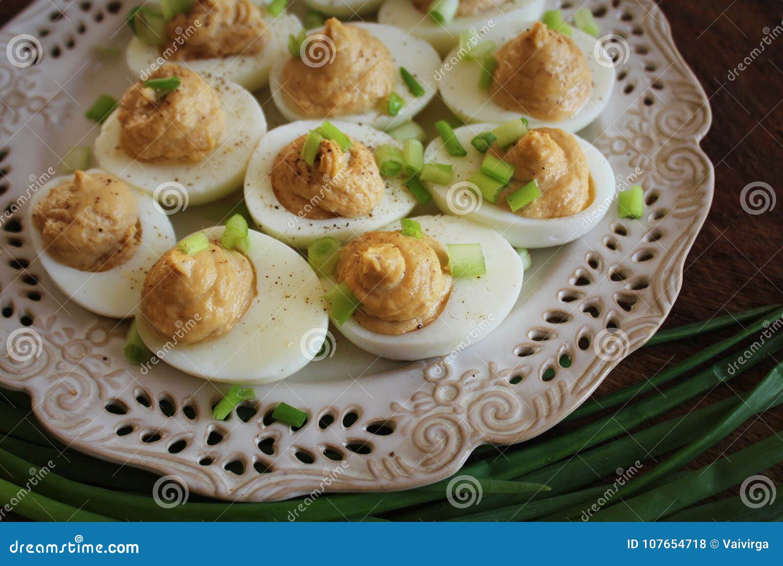 Deviled Eggs with Cod Livers with Leek on White Plate. Rustic Wooden ...