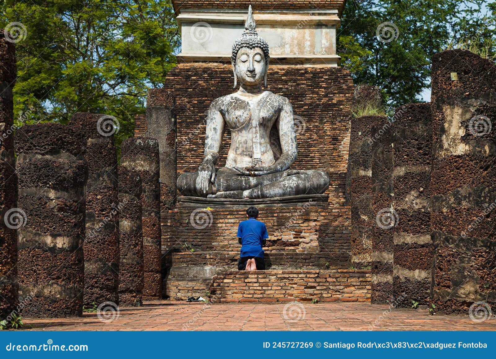 Devotee Praying And Breaking A Coconut In The Golden Cave Temple ...