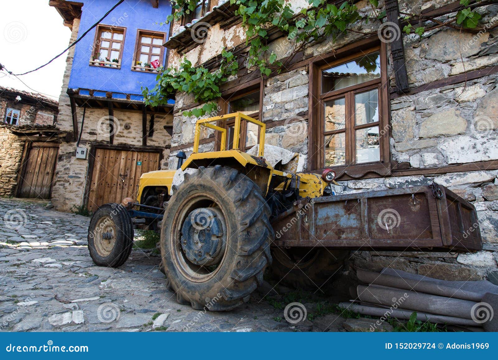 Tractor in Front of Traditional Houses Editorial Stock Image - Image of ...