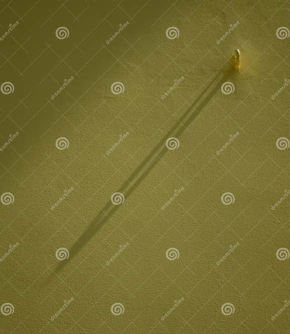 A Diagonal Shadow of a Hook on the Yellow Wall Stock Image - Image of ...
