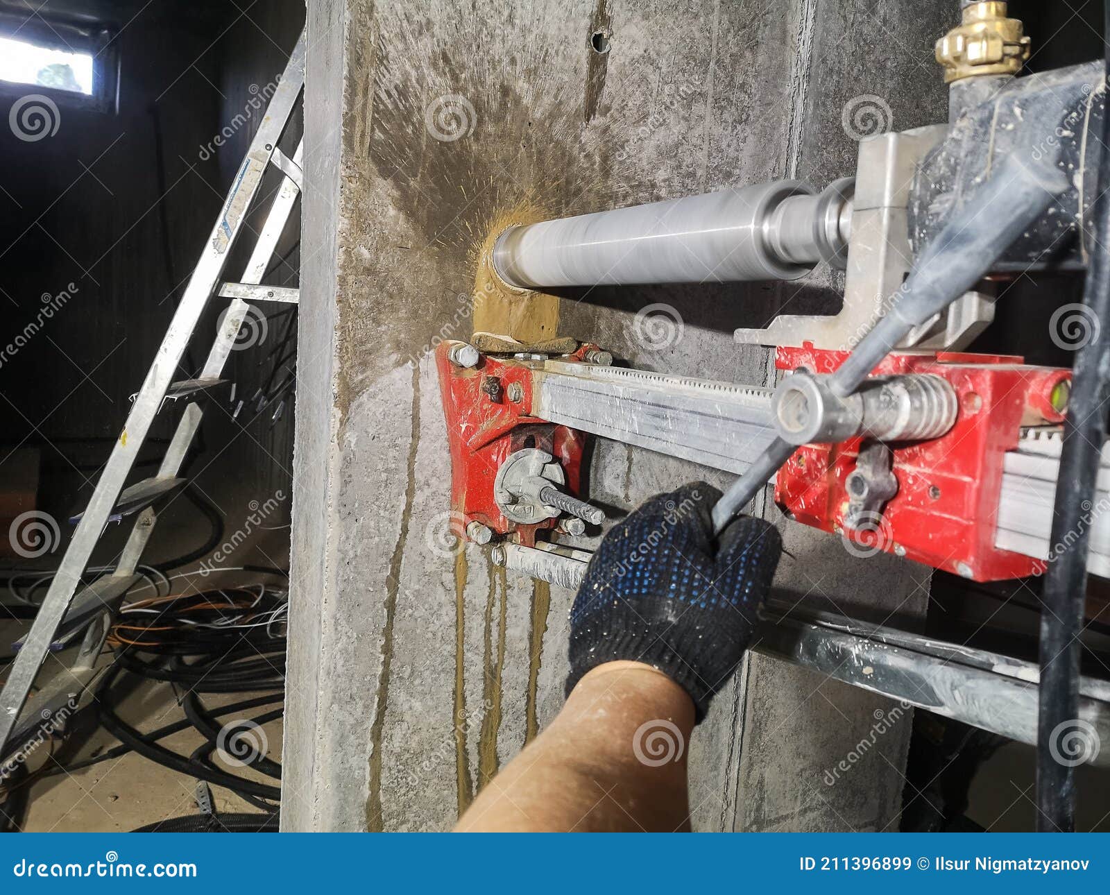 A Diamond Drill on a Machine Fixed To the Wall Drills a Hole in ...