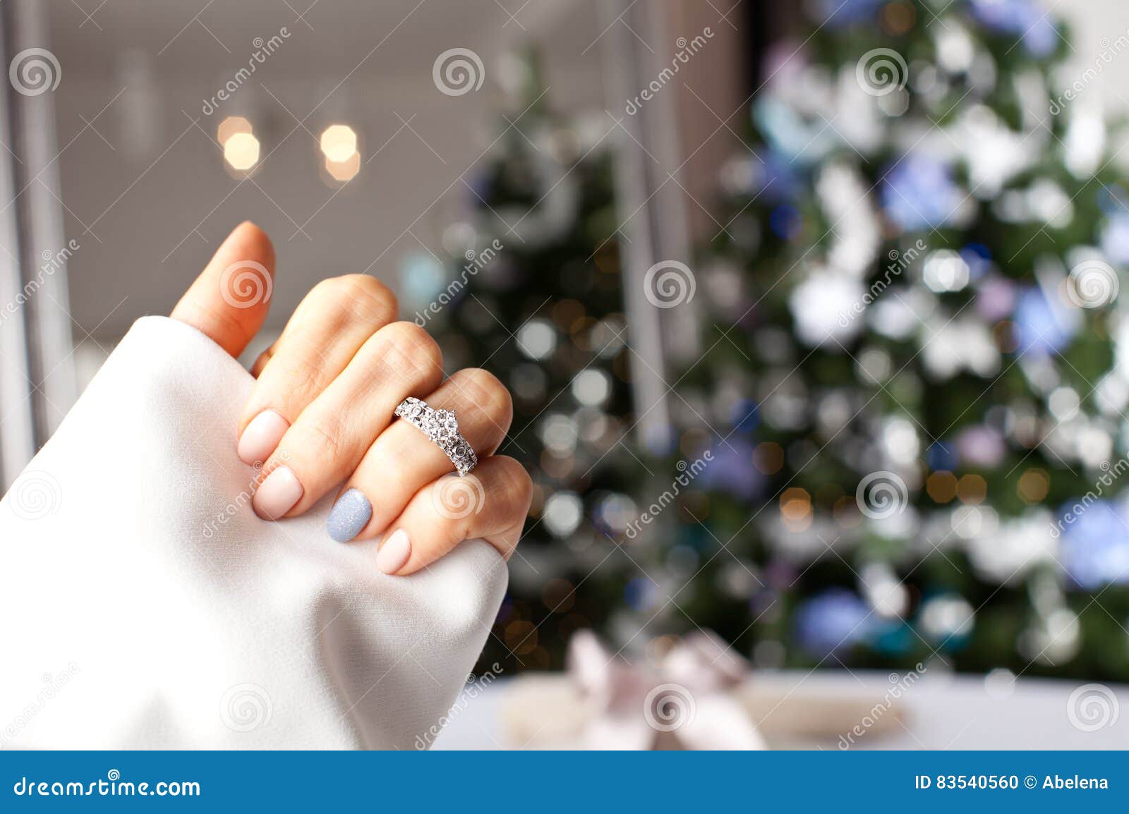 Diamond Ring on a Finger Under the Christmas Tree. Stock Photo - Image ...