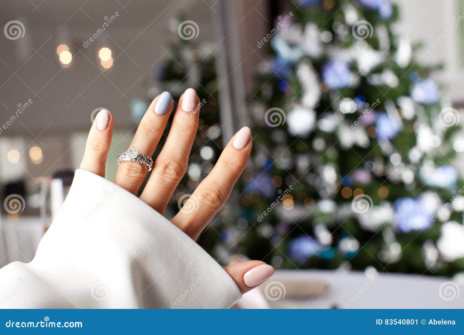 Diamond Ring on a Finger Under the Christmas Tree. Stock Image - Image ...