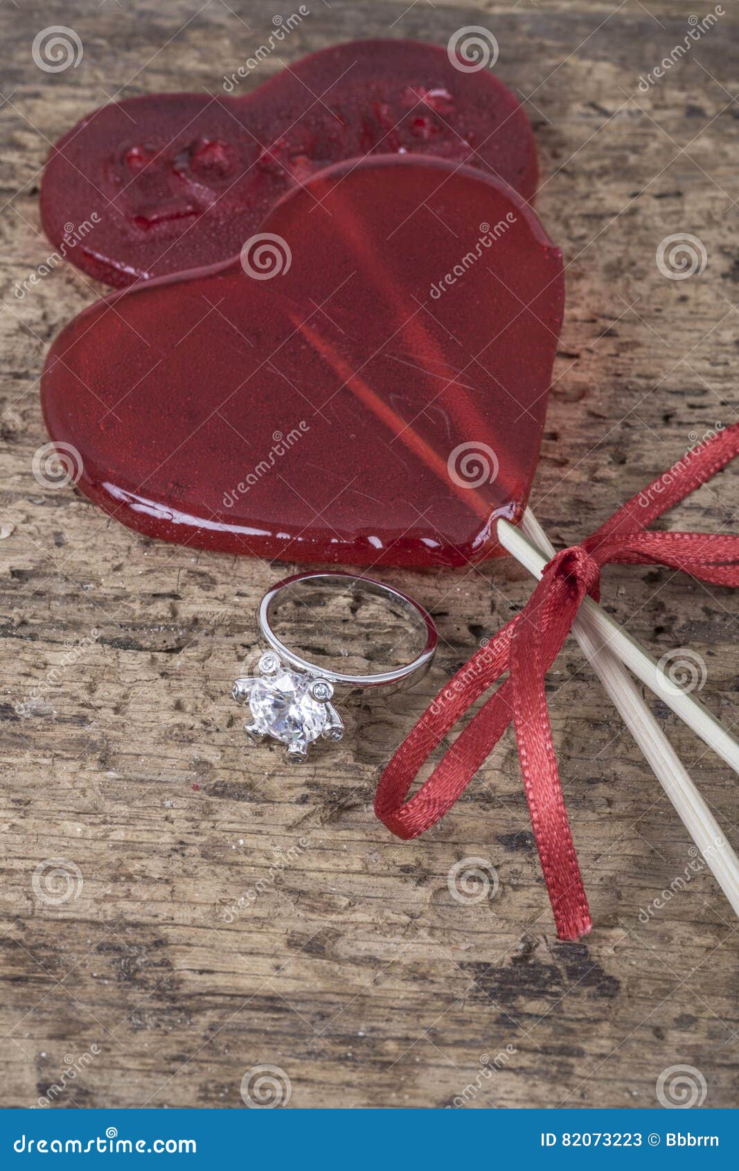 Diamond Ring and Heart Shaped Candies on Wooden Surface Stock Image ...