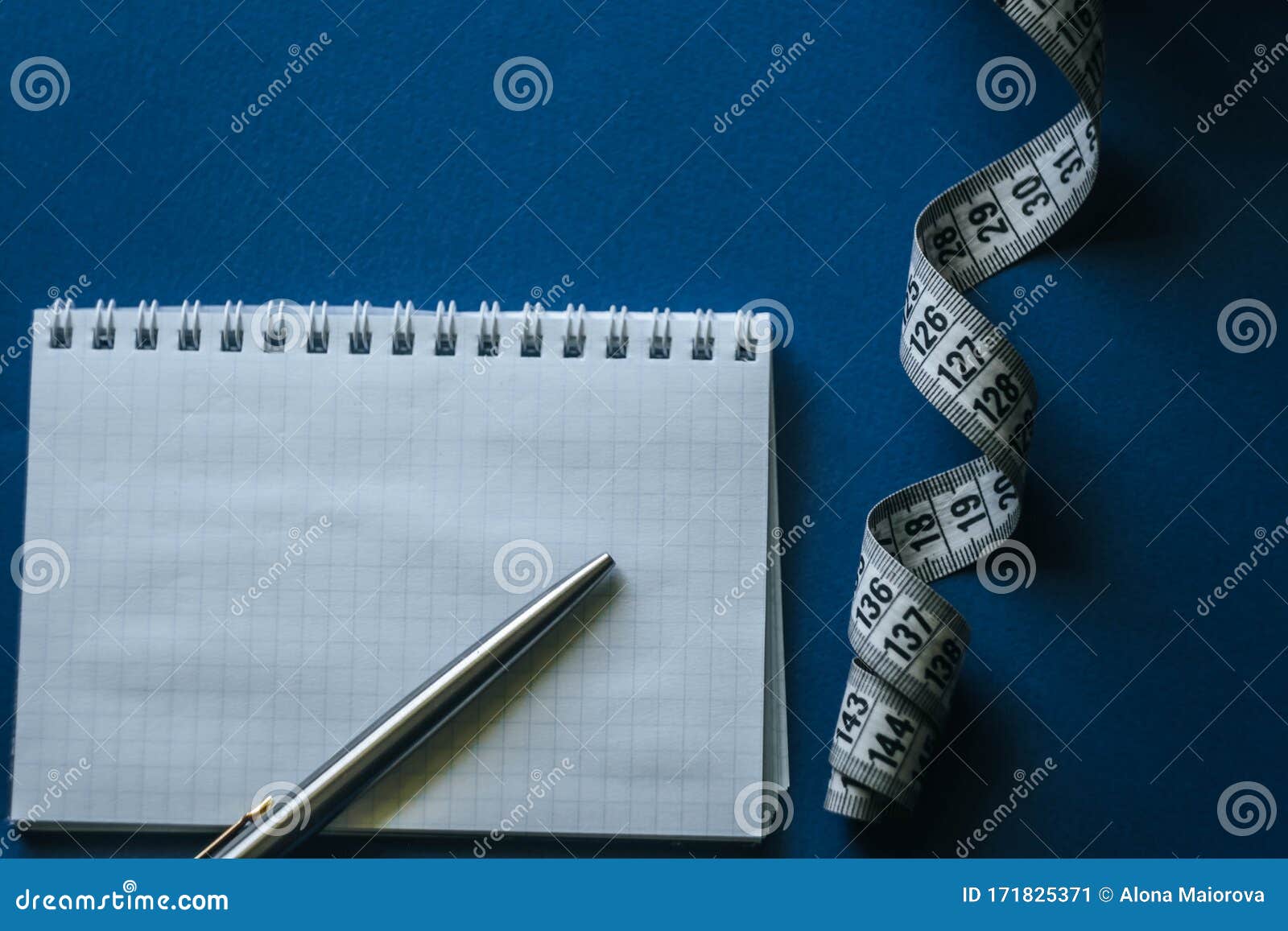Notepad with Measuring Tape on Blue Background Stock Image - Image of ...