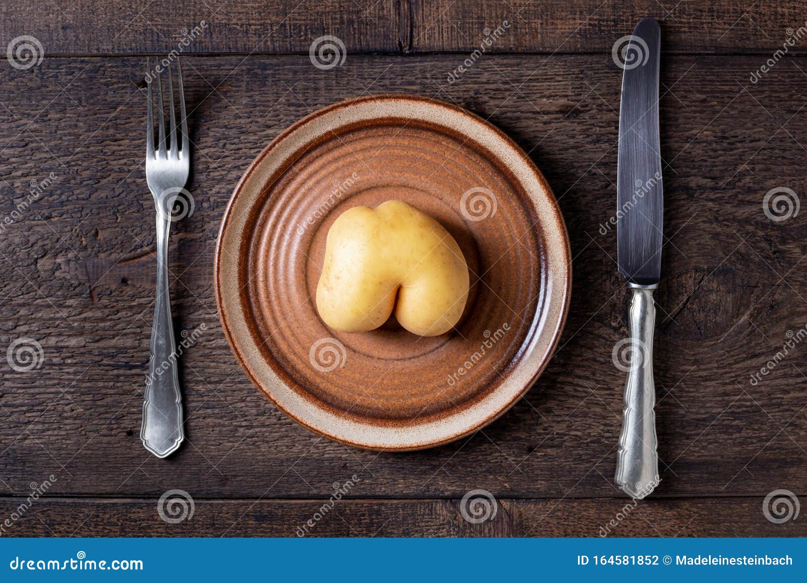 Dieting Concept - Single Potato in the Form of Buttocks on a Plate ...