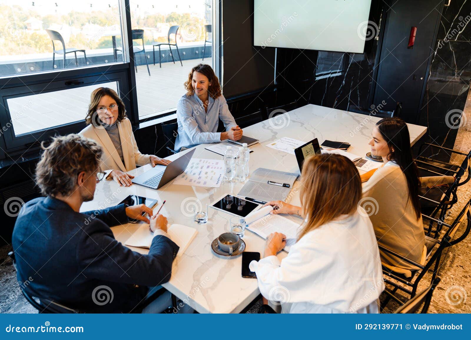 Different Age Colleagues Discussing Their Project during Offline ...