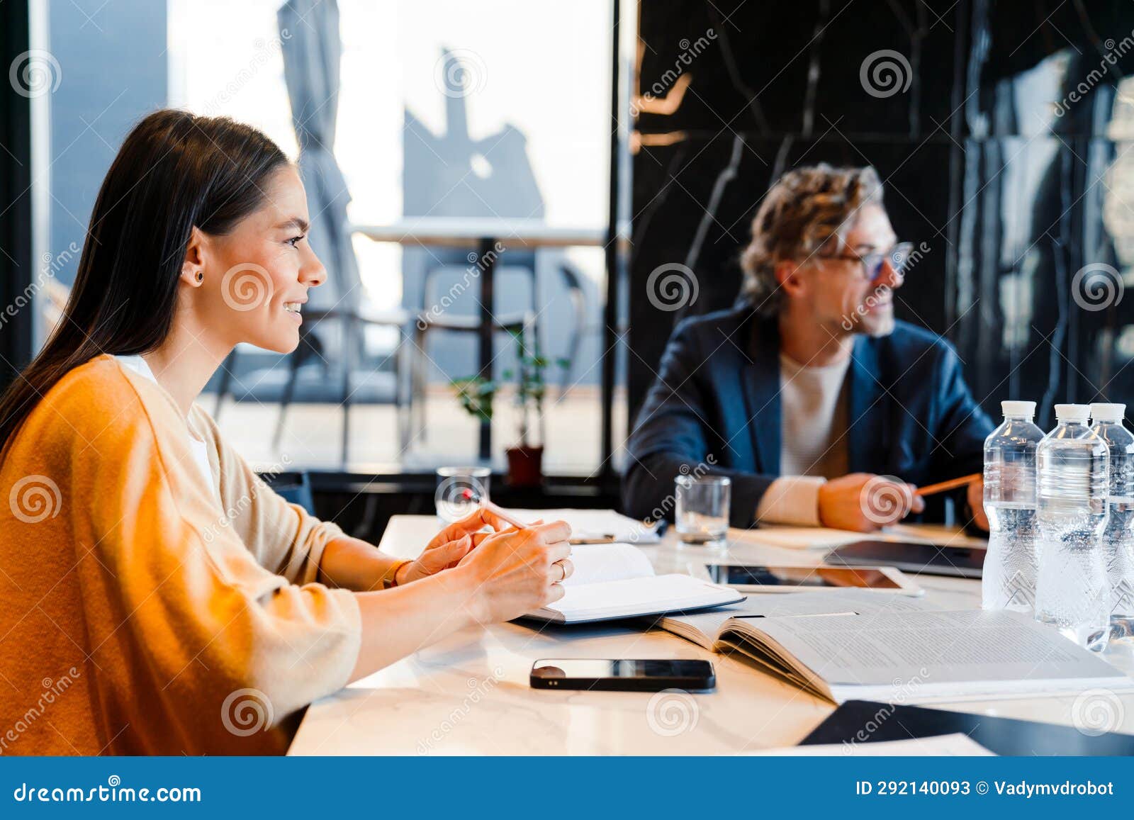 Different Age Colleagues Discussing Their Project during Offline ...