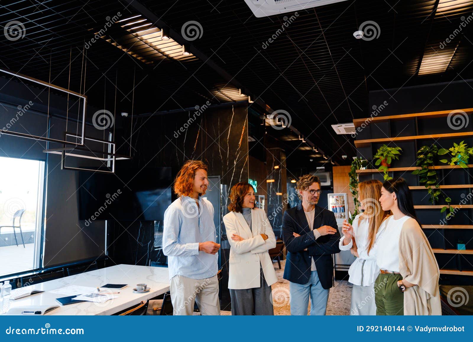 Different Age Colleagues Discussing Their Project during Offline ...