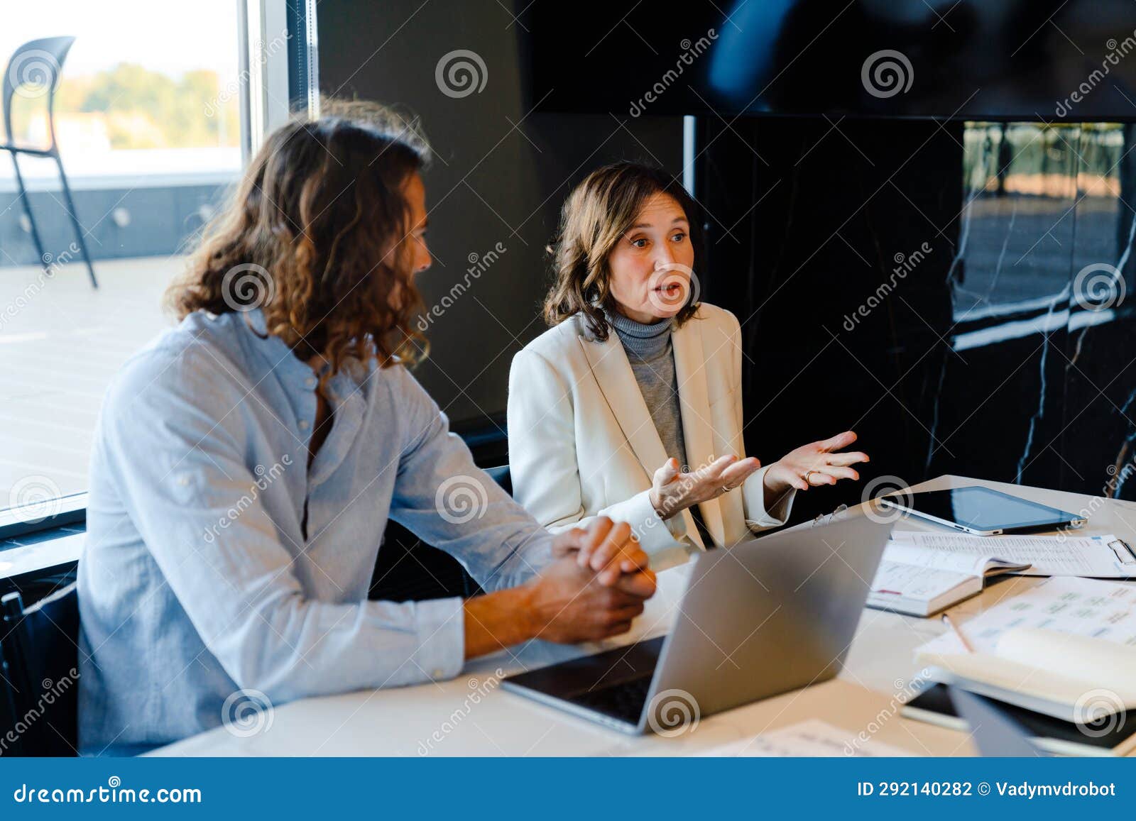 Different Age Colleagues Discussing Their Project during Offline ...