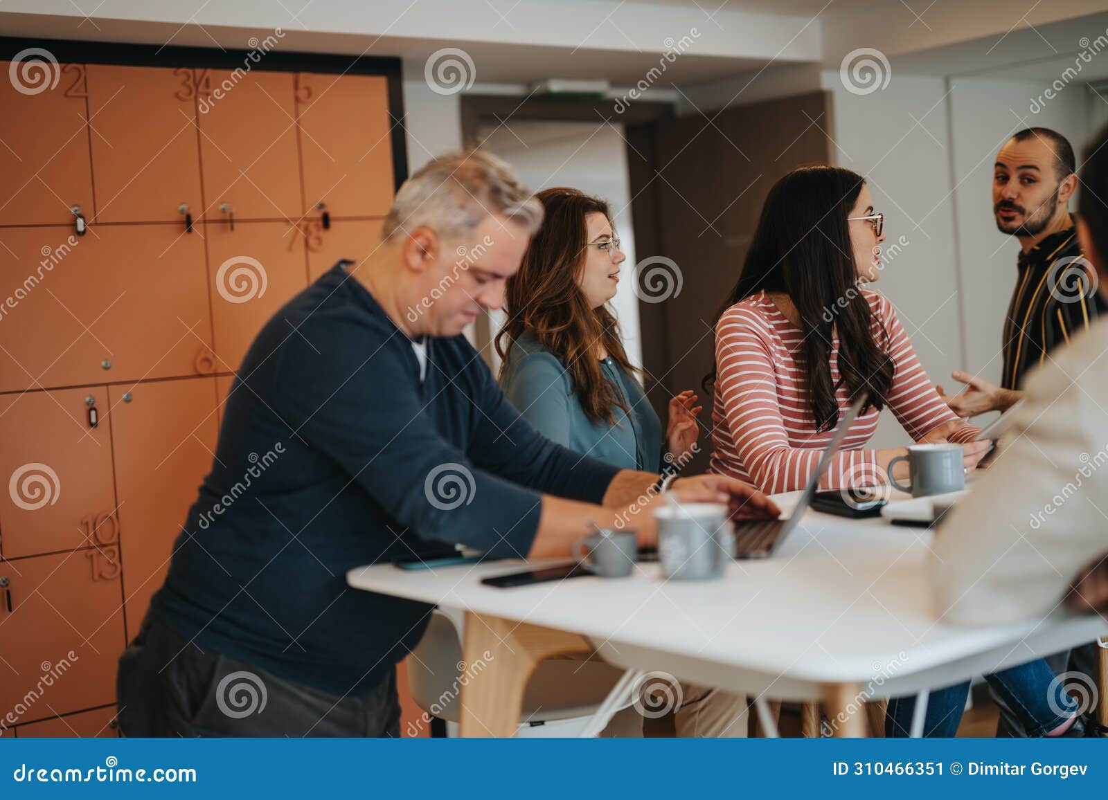 A Different Aged Group of Company Employees Engage in a Collaborative ...
