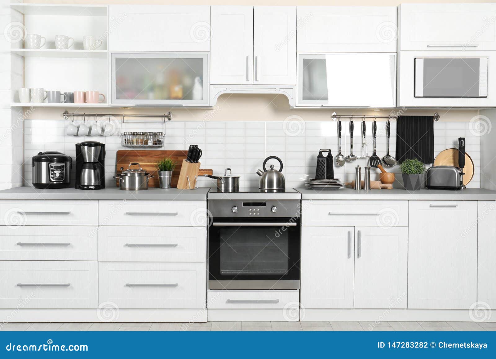 Different Appliances, Clean Dishes on Kitchen Counter Stock Photo ...