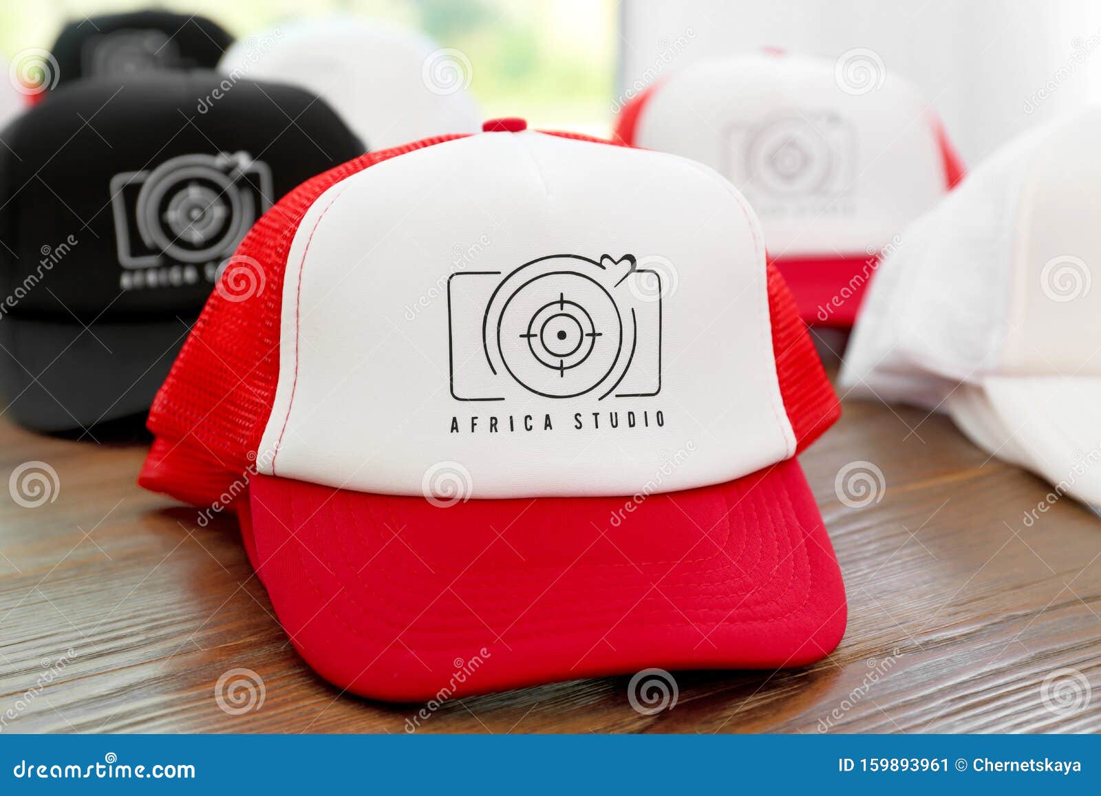 Different Caps with Logo on Table Stock Image - Image of background ...