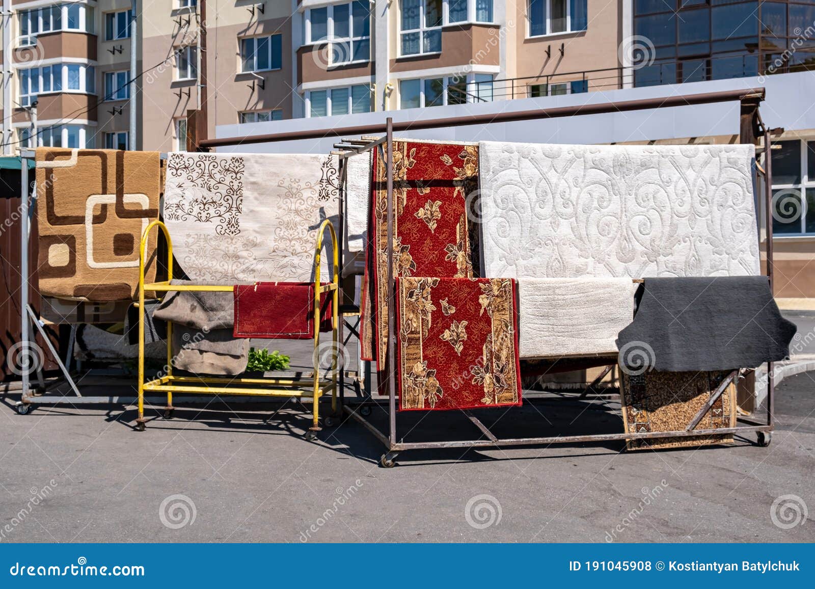 Different Carpets Hanging on Rack Outdoors. Professional Carpet ...