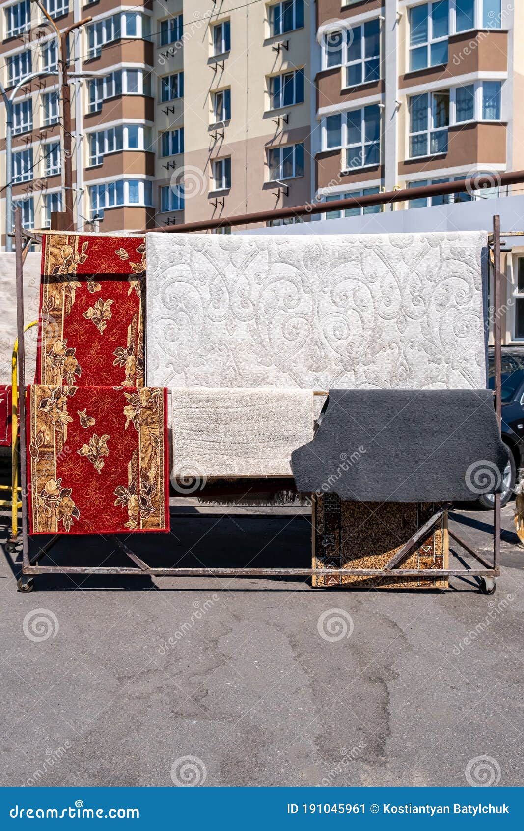 Different Carpets Hanging on Rack Outdoors. Professional Carpet ...