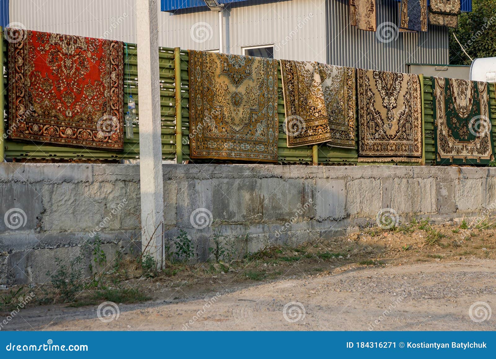 Different Carpets Hanging on Rack Outdoors. Professional Carpet ...