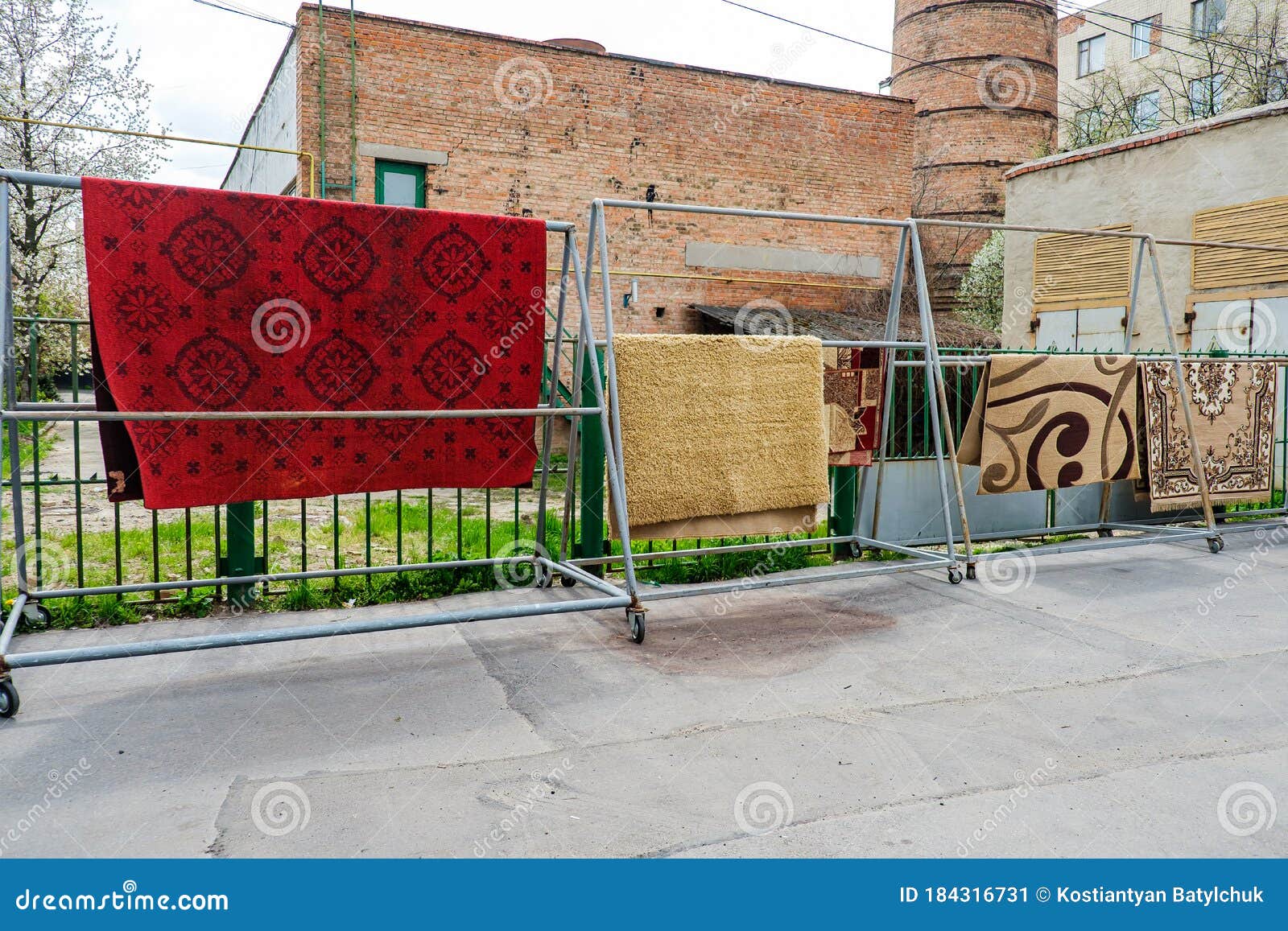 Different Carpets Hanging on Rack Outdoors. Professional Carpet ...