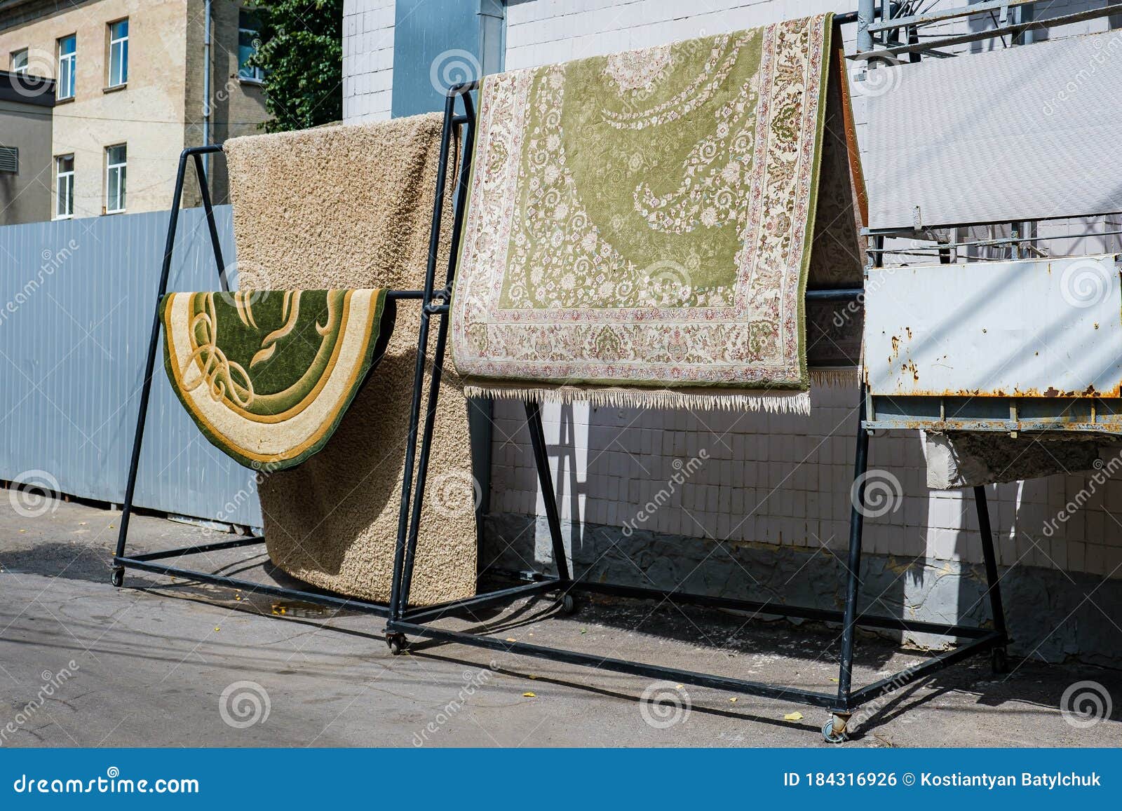 Different Carpets Hanging on Rack Outdoors. Professional Carpet ...