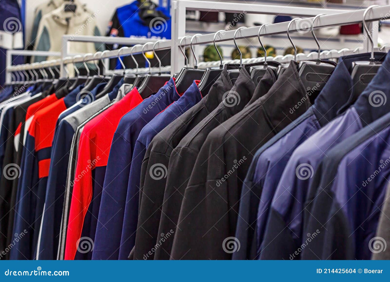 Different Casual Clothes Hanging in the Retail Clothing Store. Stock ...