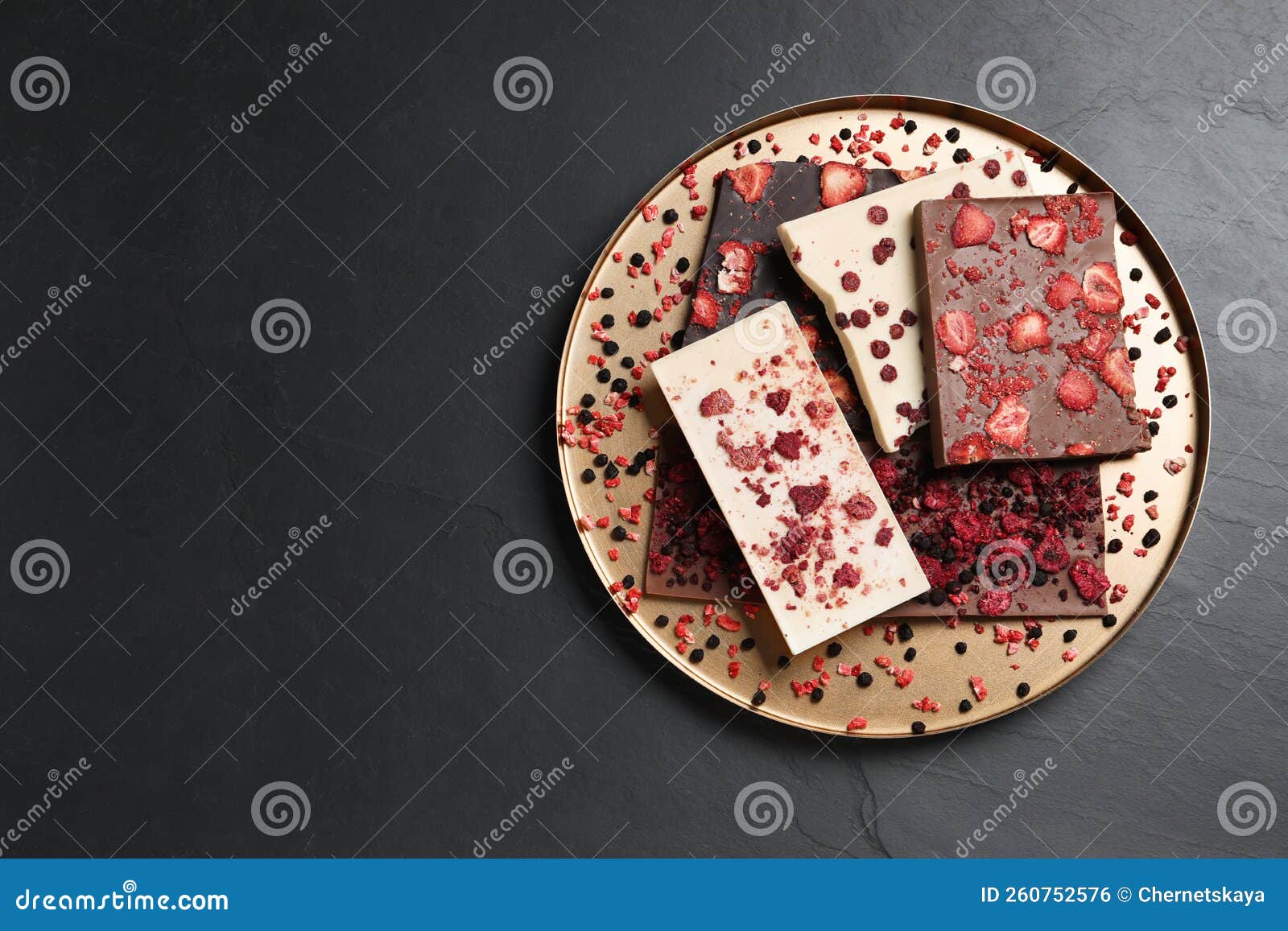 Different Chocolate Bars with Freeze Dried Fruits on Black Table, Top ...