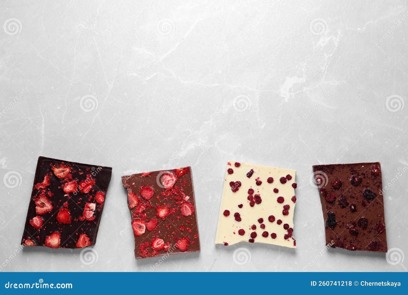 Different Chocolate Bars with Freeze Dried Fruits on Light Marble Table ...