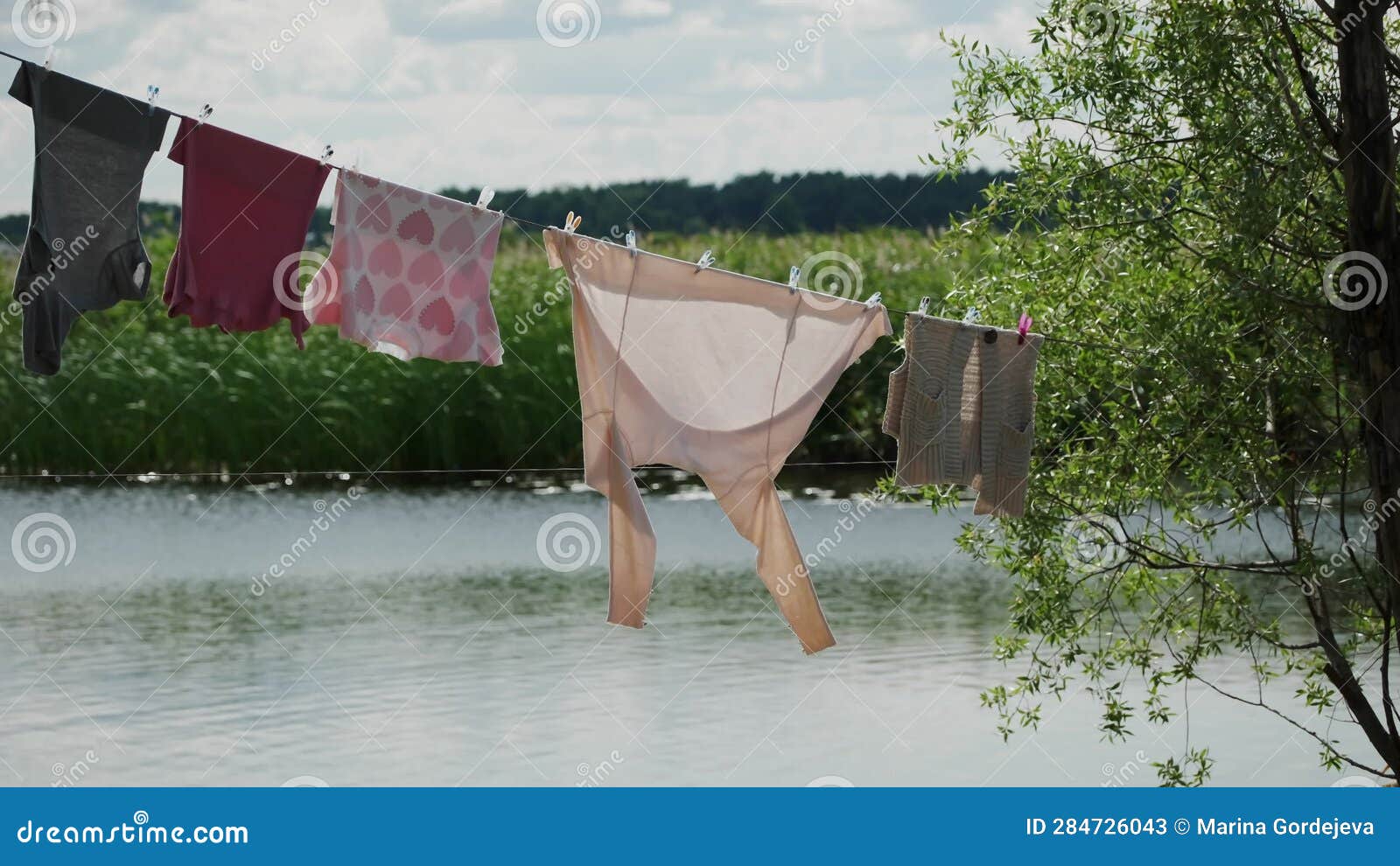 Different Clothes Dry on the Line after Washing Against the Backdrop of ...