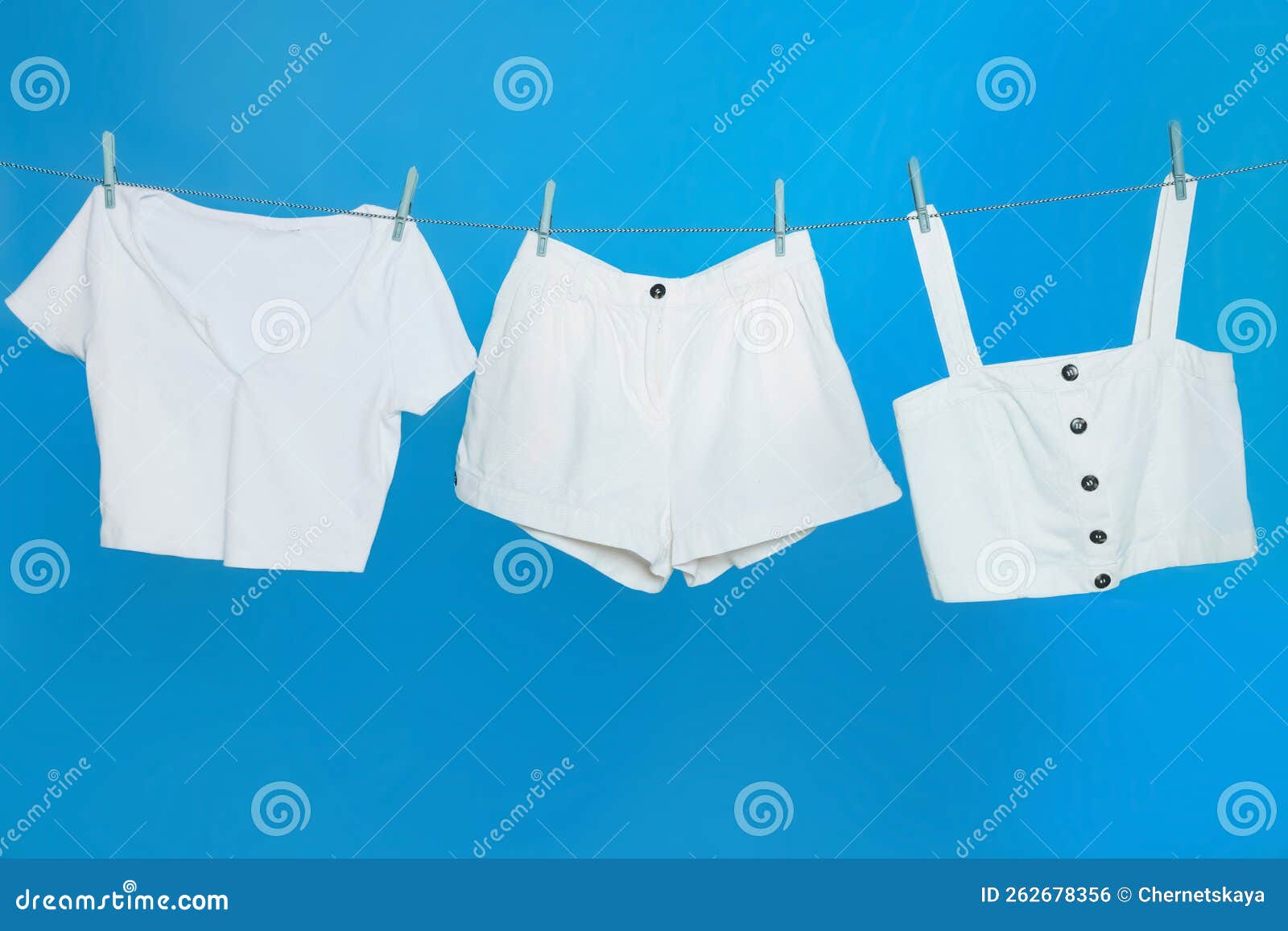 Different Clothes Drying on Laundry Line Against Light Blue Background ...