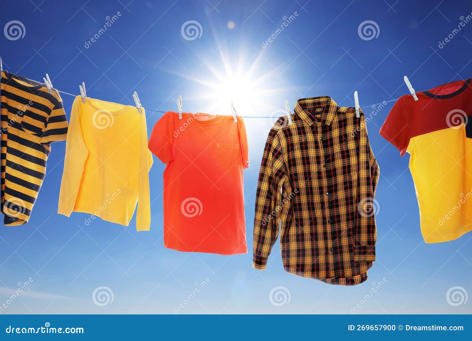 Different Clothes Drying on Washing Line Against Blue Sky Stock Photo ...
