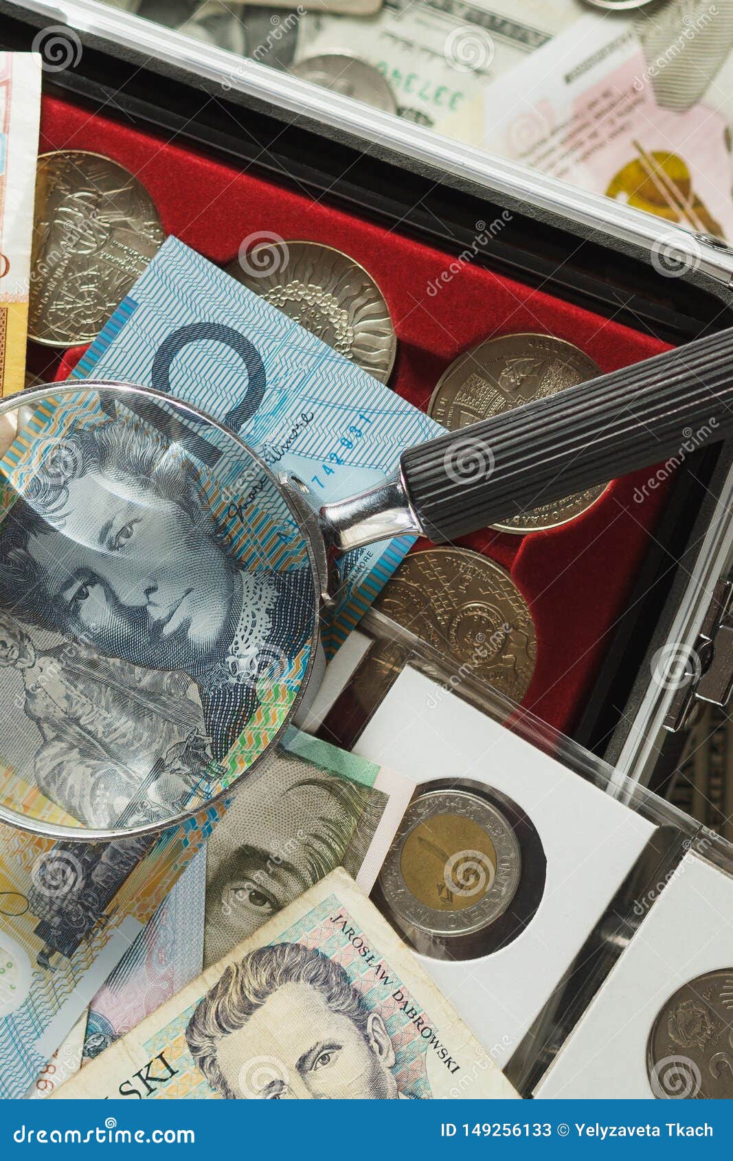 Different Collector`s Coins and Banknotes with a Magnifying Glass Stock ...