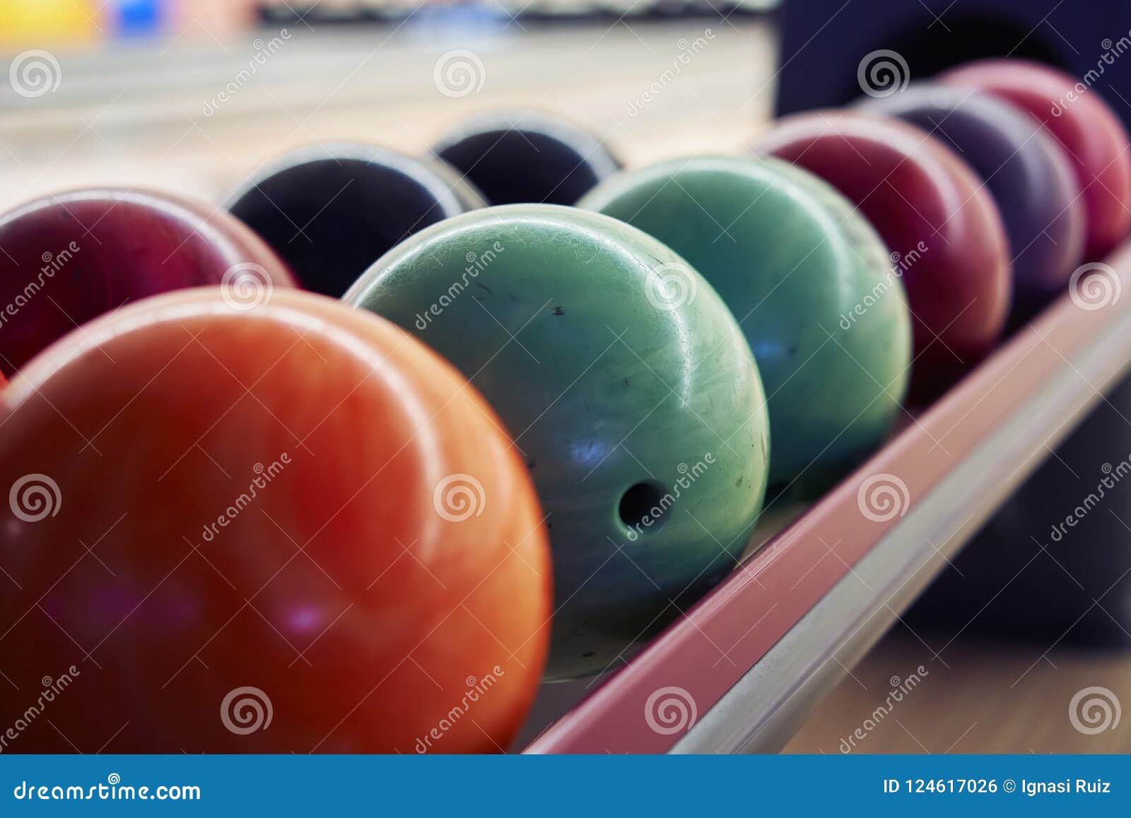 Bowling balls in a row stock photo. Image of pink, brown - 124617026