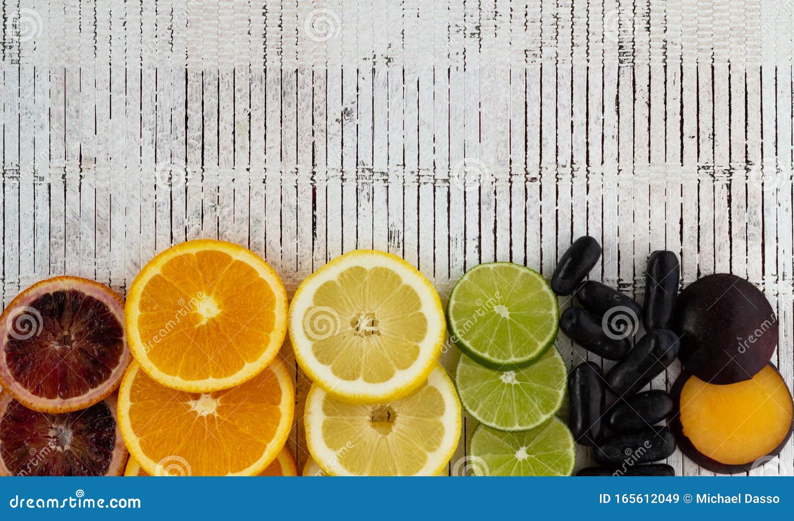 Different Colored Fruit on a White Plank Background. Copyspace ...