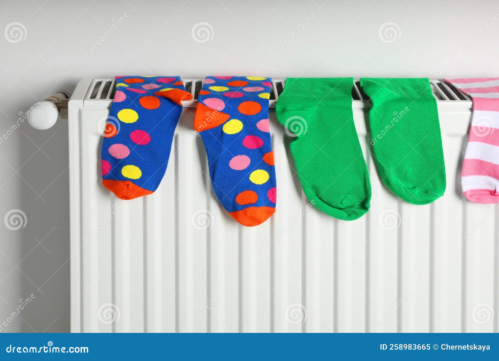 Different Colorful Socks on Heating Radiator Near White Wall Stock ...