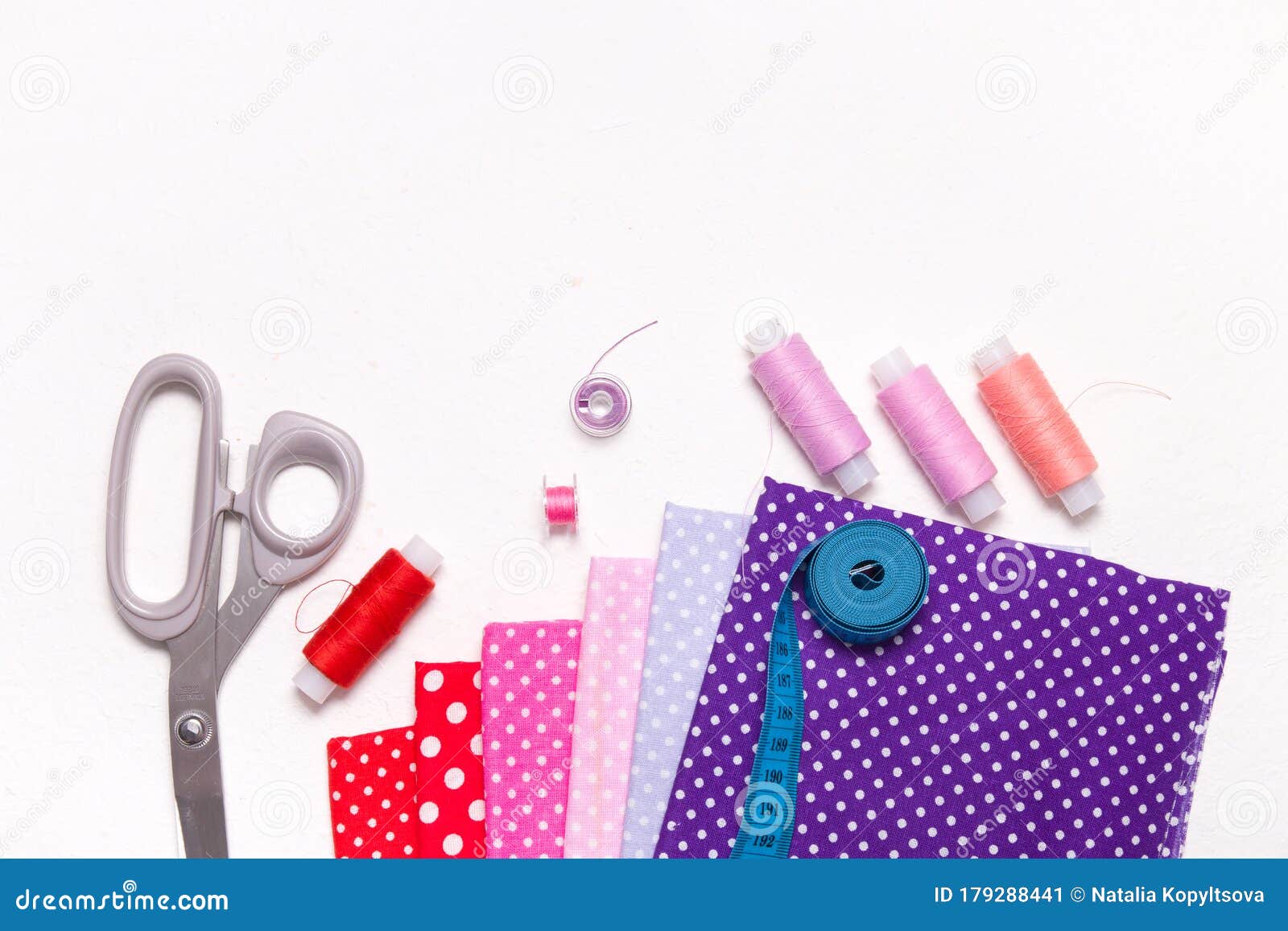 Different Colors of Fabric with a Pattern, Scissors and Spools of ...