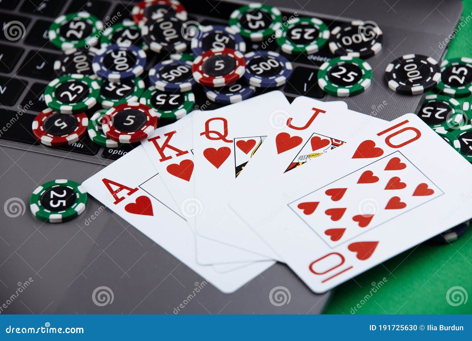 Different of Cost Casino Chips Stacking and Playing Cards on a Laptop ...