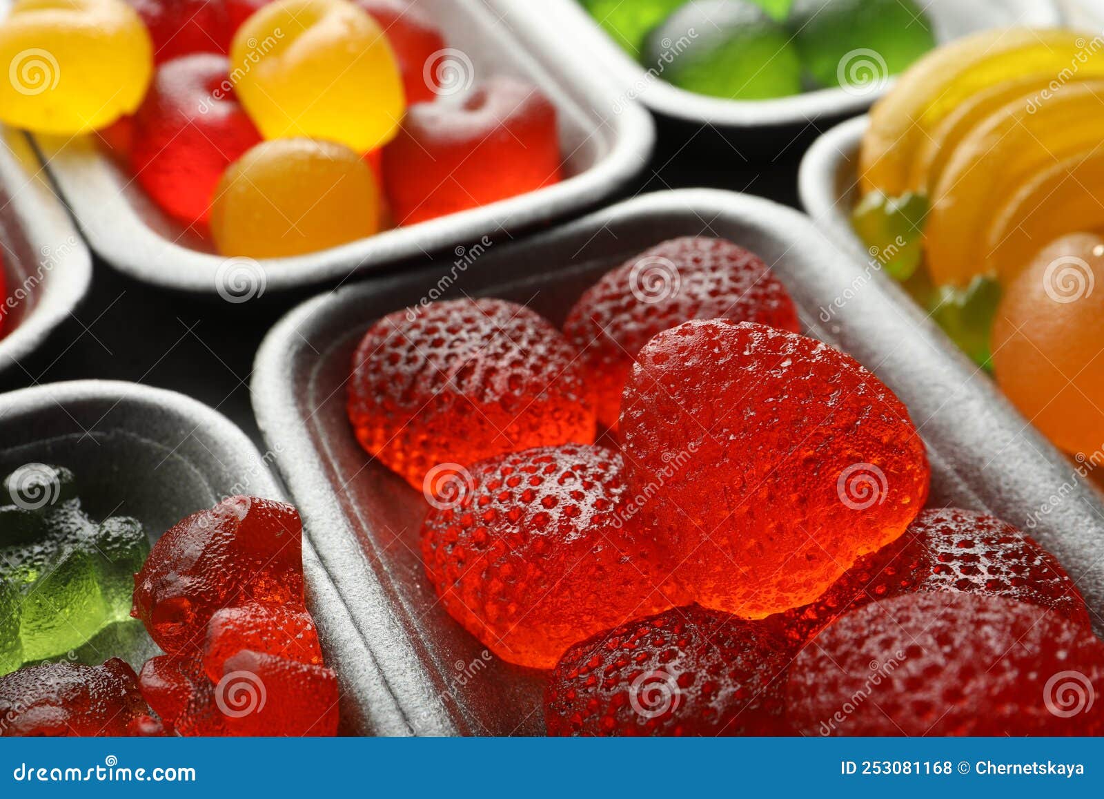 Different Delicious Gummy Candies in Containers, Closeup Stock Photo ...