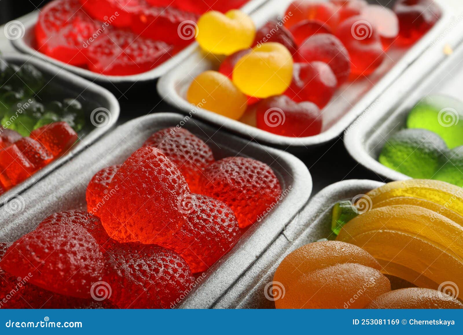 Different Delicious Gummy Candies in Containers, Closeup Stock Image ...