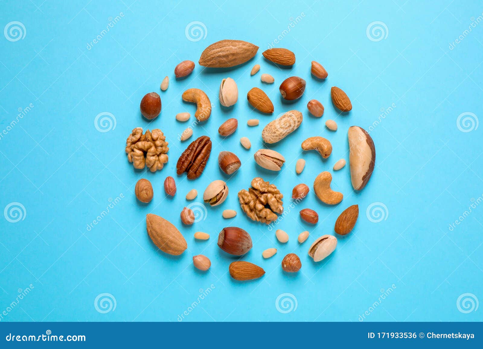 Different Delicious Nuts on Light Blue Background Stock Photo - Image ...