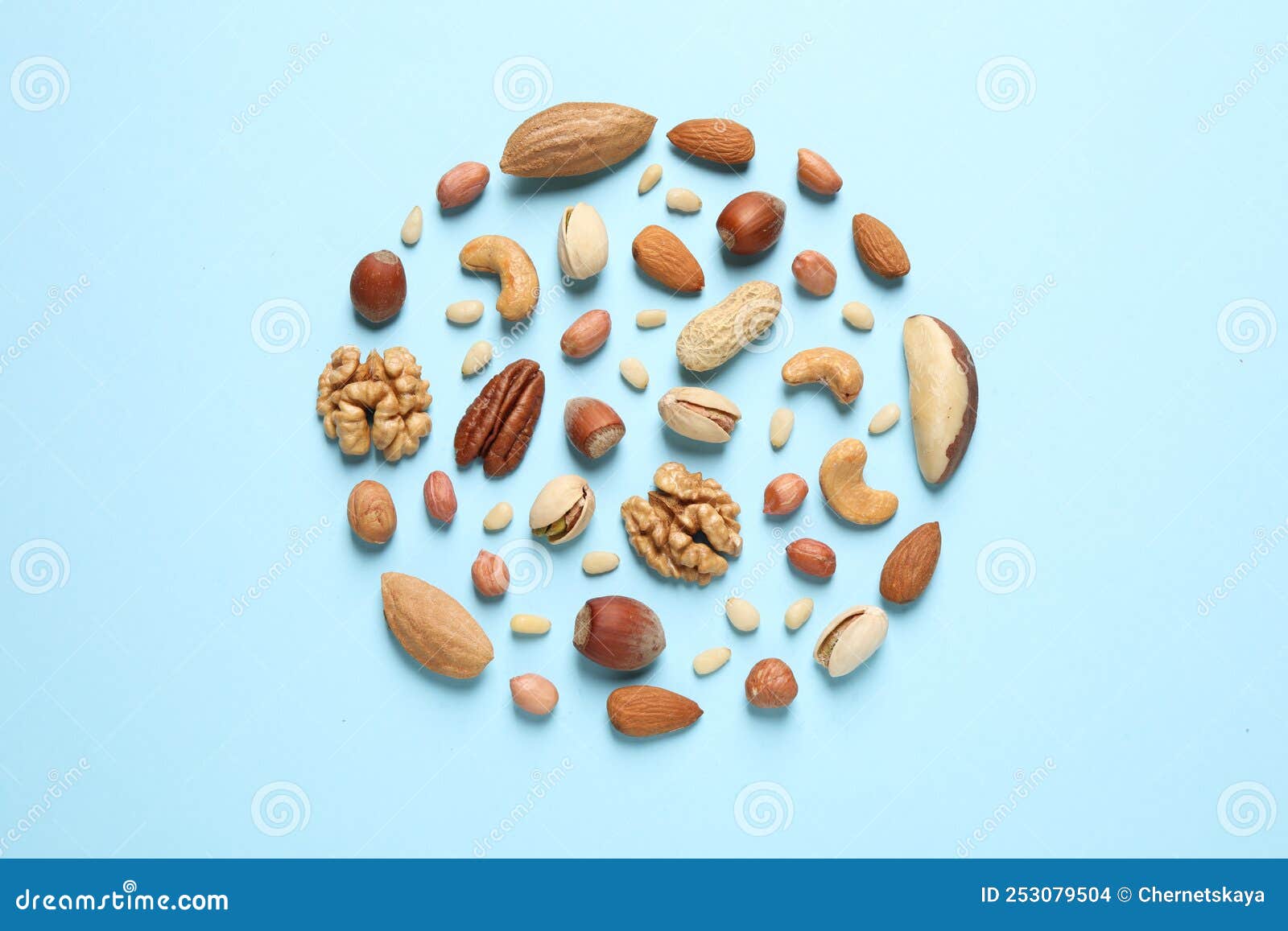 Different Delicious Nuts on Light Blue Background, Flat Lay Stock Photo ...