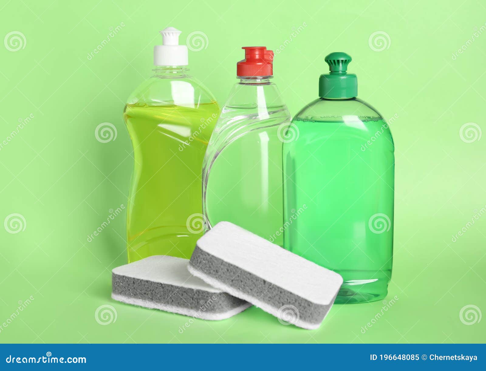 Different Detergents and Sponges on Green Background Stock Image ...